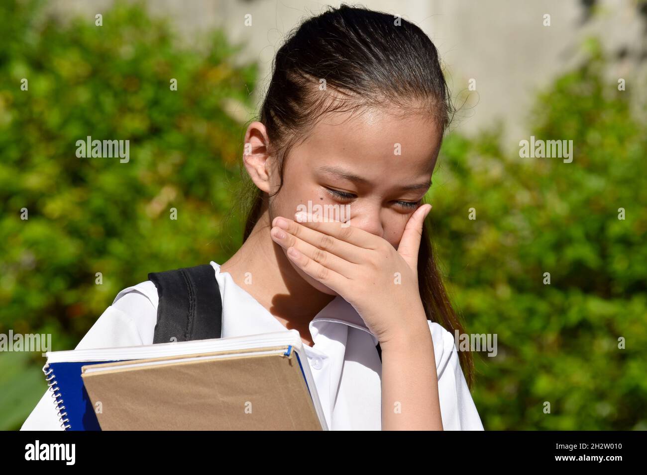 Tearful Filipina Female Student With Textbooks Stock Photo - Alamy