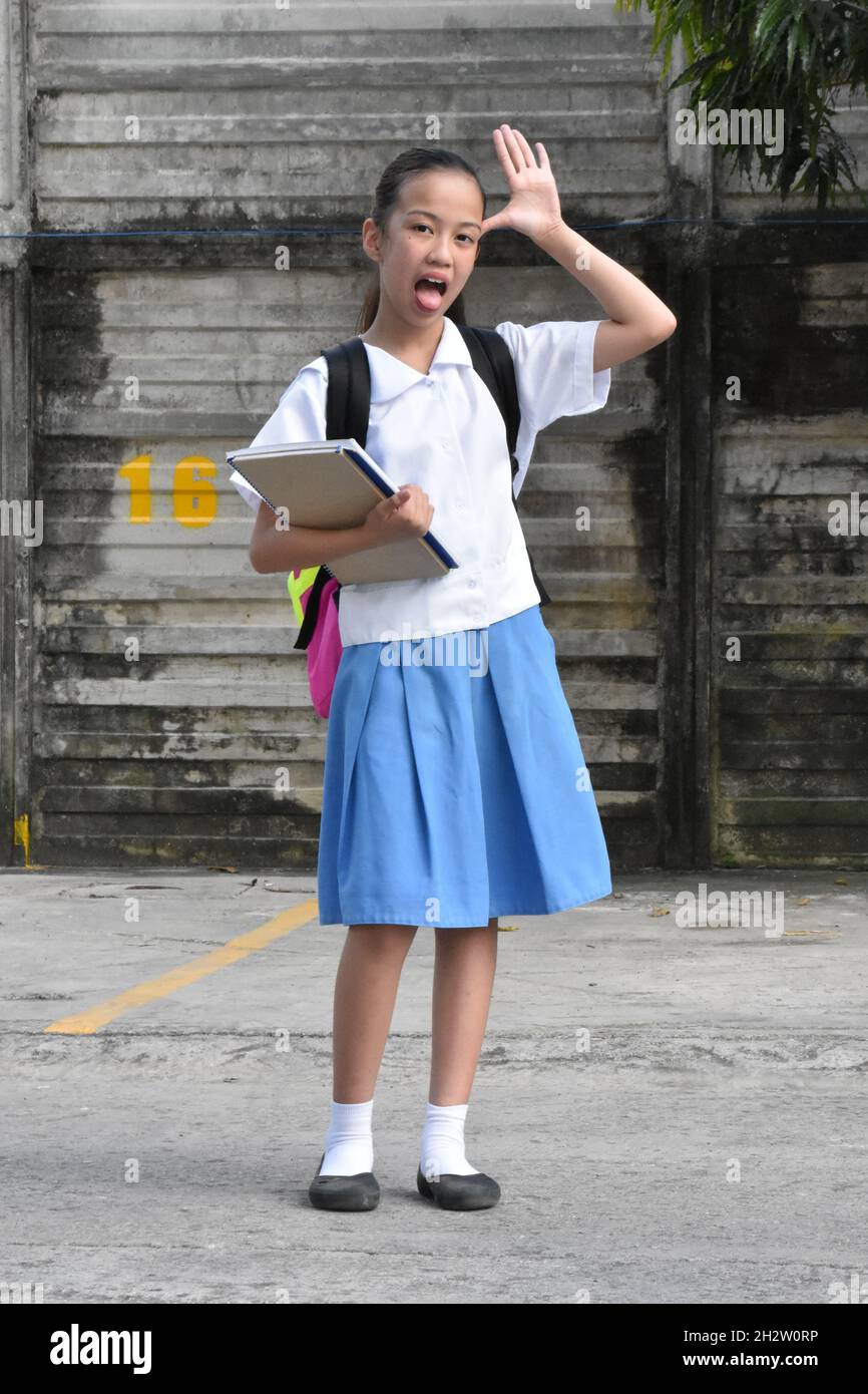 Female Student Making Funny Faces Wearing Uniform With School Books ...