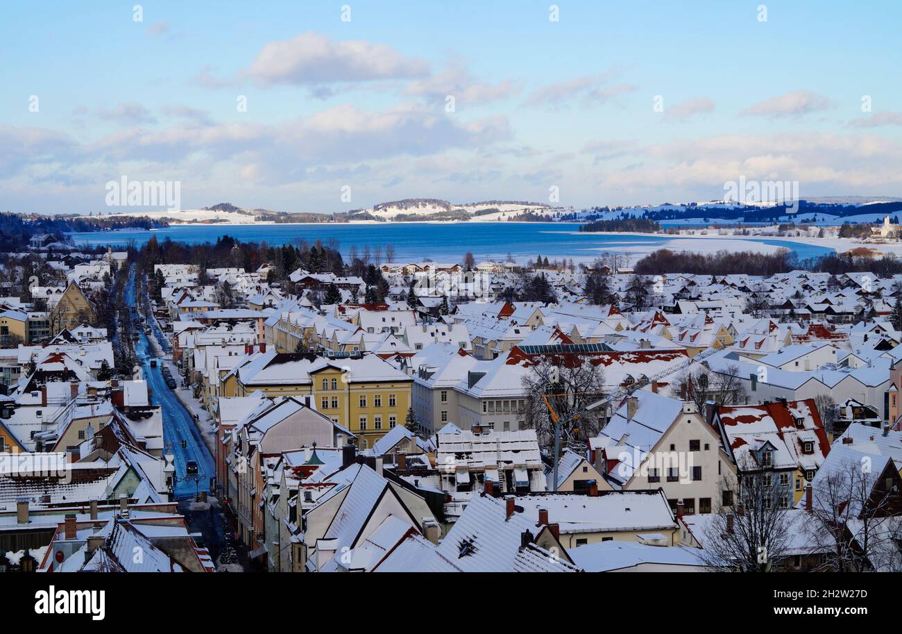 over the wintery Fuessen covered with snow with lake Forggensee and the ...