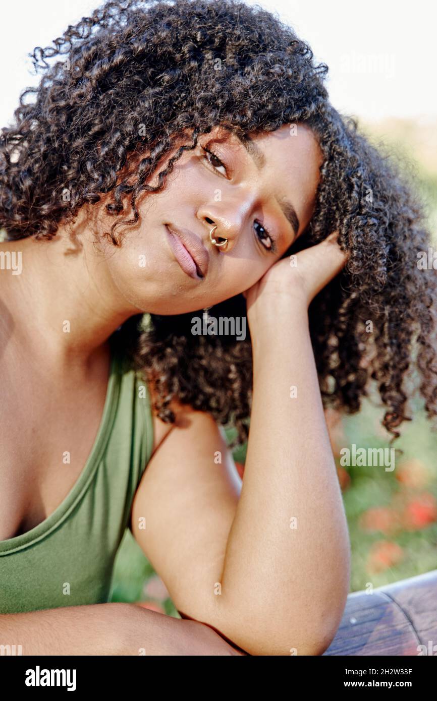 bored woman resting her head on her hand Stock Photo - Alamy