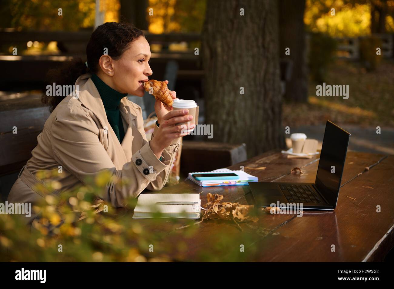 A confident freelance woman, serene business lady goes for coffee break ...