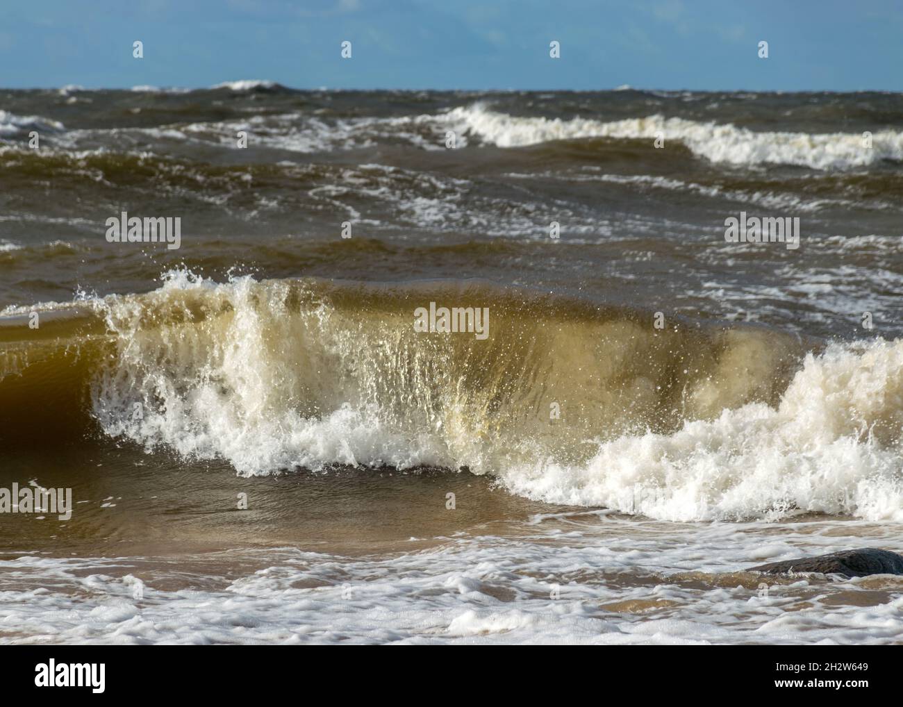 beautiful wave on the beach, background blur and waves in sunlight ...