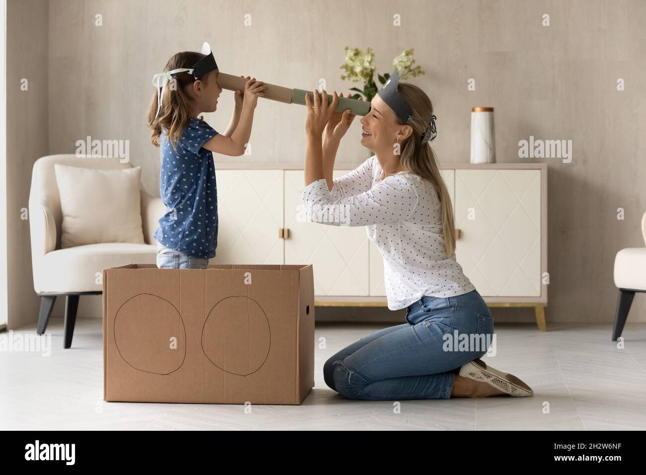 Happy adorable kid girl playing pirates game with mum Stock Photo - Alamy