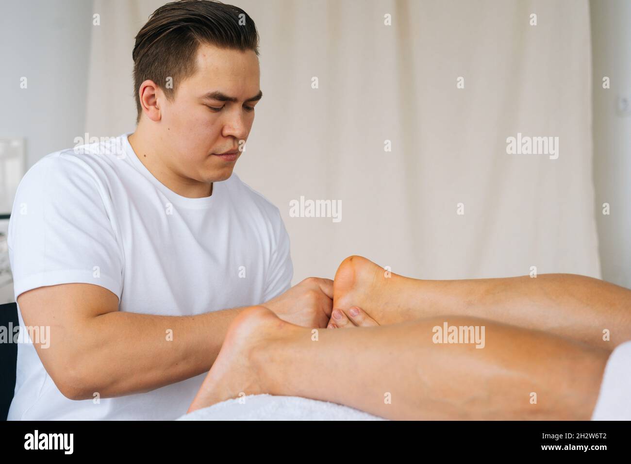 Close Up Cropped Shot Of Professional Male Masseur With Strong Hands