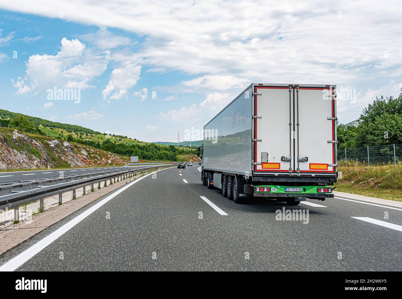 A cargo van drives on a country road Stock Photo - Alamy