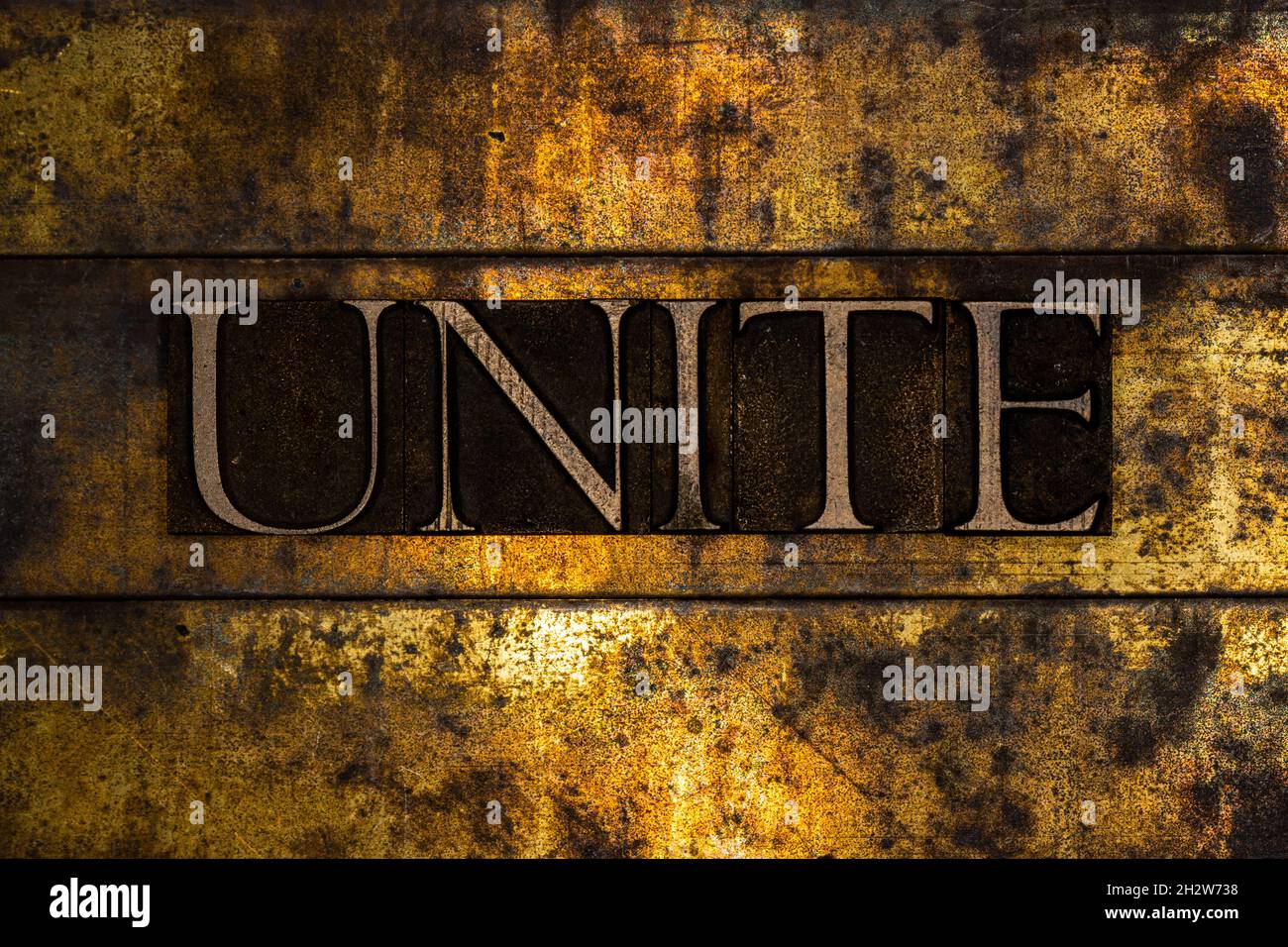 Unite text on textured grunge copper and vintage gold background Stock ...