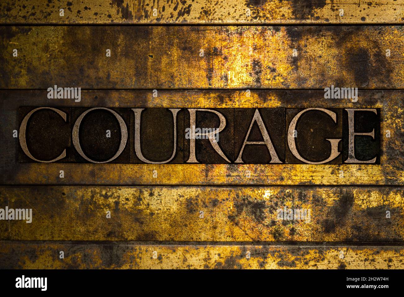 Courage text on vintage textured bronze grunge copper and gold ...