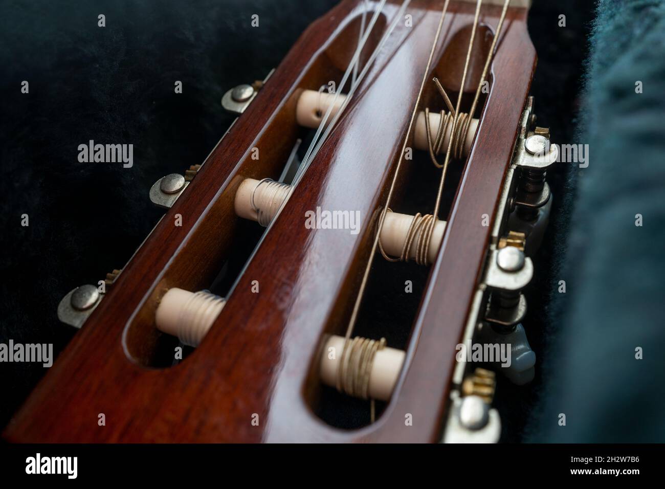 Guitar Arm on black background from hard case. Classic acoustic guitar ...