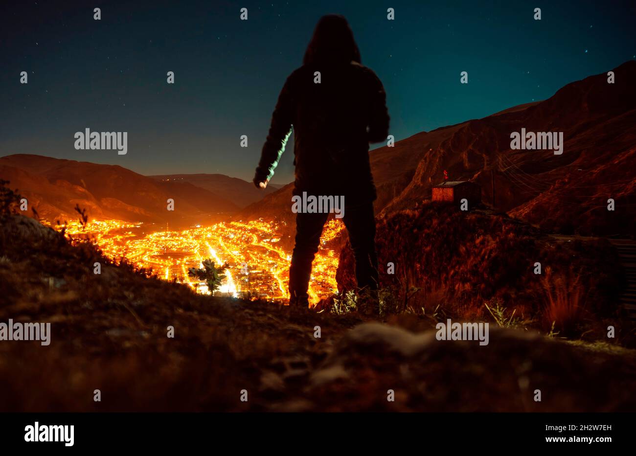 A high angle view of a guy standing on the top of the gorge with a view ...