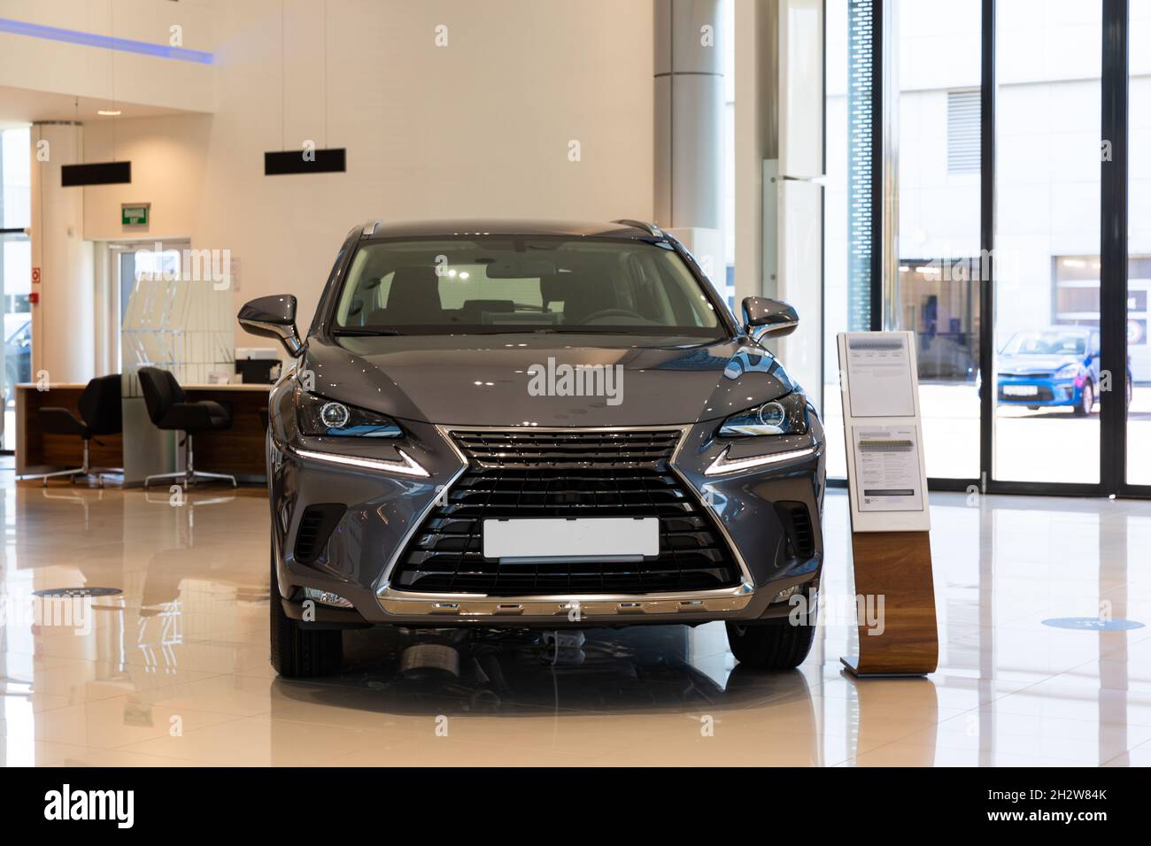 new gray car in modern dealer showroom Stock Photo - Alamy