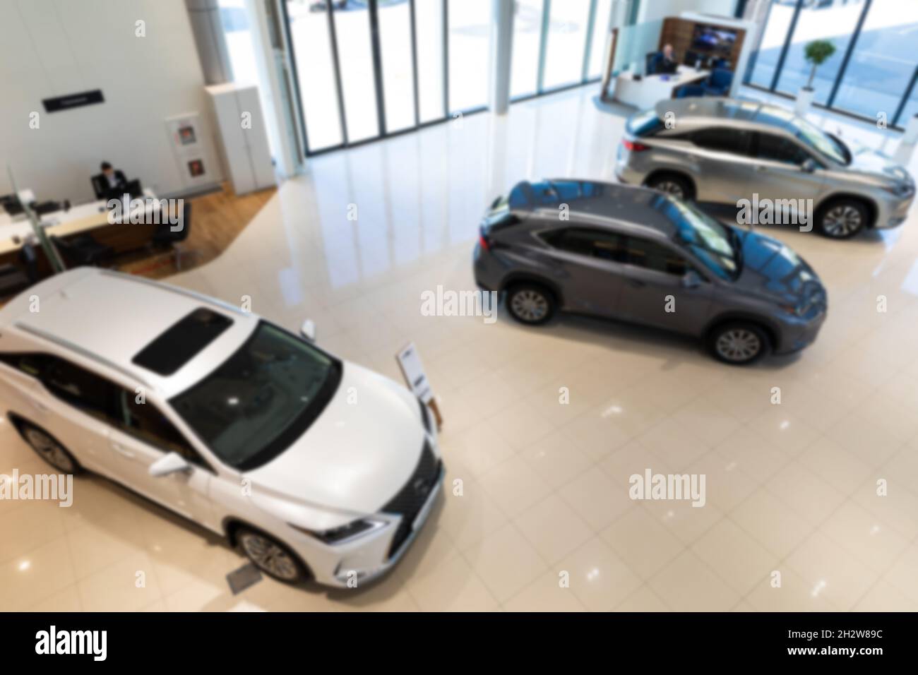 stylish modern car showroom, dealer office with new cars inside, blur ...