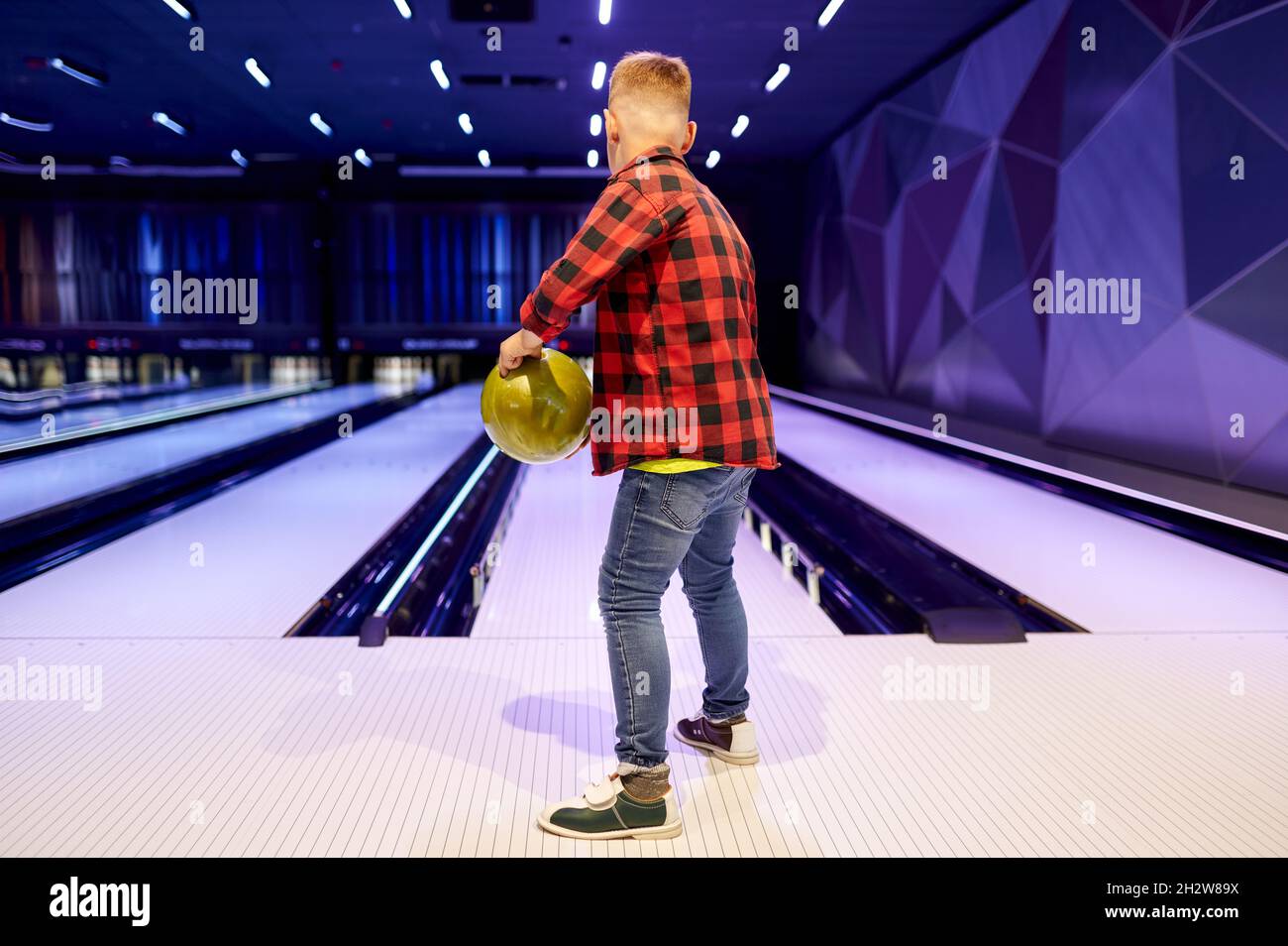 Boy playing bowling alley hi-res stock photography and images - Alamy