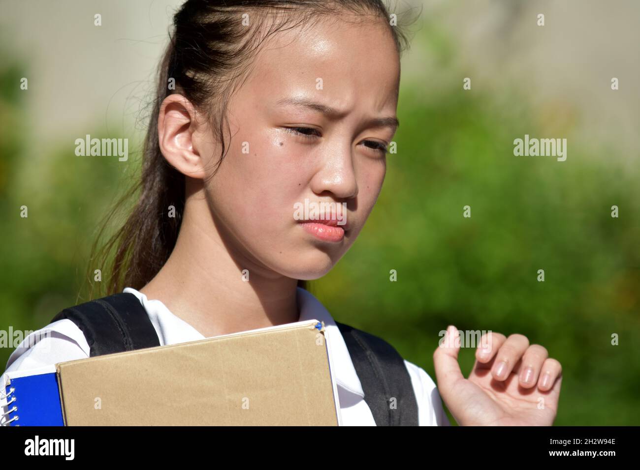 Unhappy Filipina Girl Student With Textbooks Stock Photo - Alamy