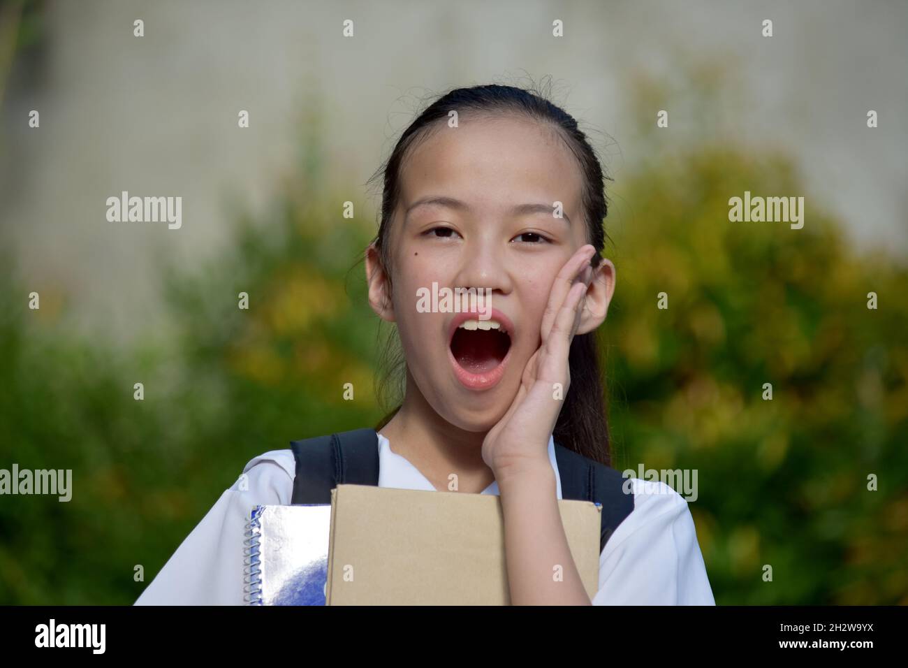 Startled Youthful Filipina Girl Student With Notebooks Stock Photo - Alamy