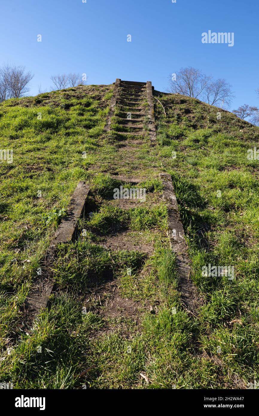 Old hill stairs partially covered with soil and grass, forgotten way to ...