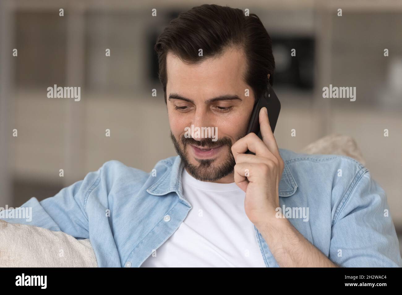 Head shot smiling young man involved in phone call conversation Stock ...