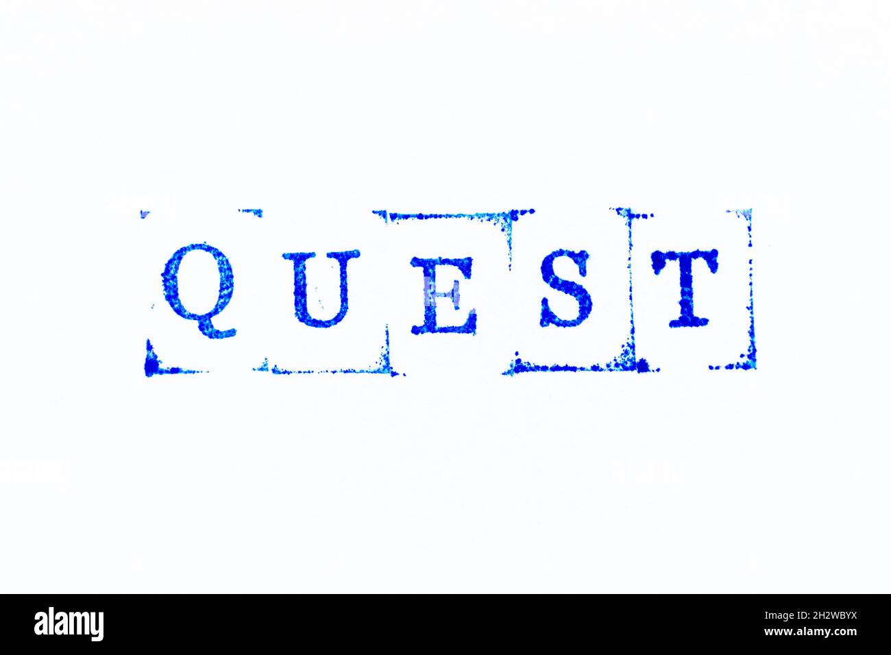 Blue color ink rubber stamp in word quest on white paper background ...