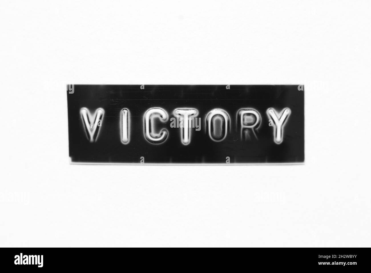 Black color banner that have embossed letter with word victory on white ...