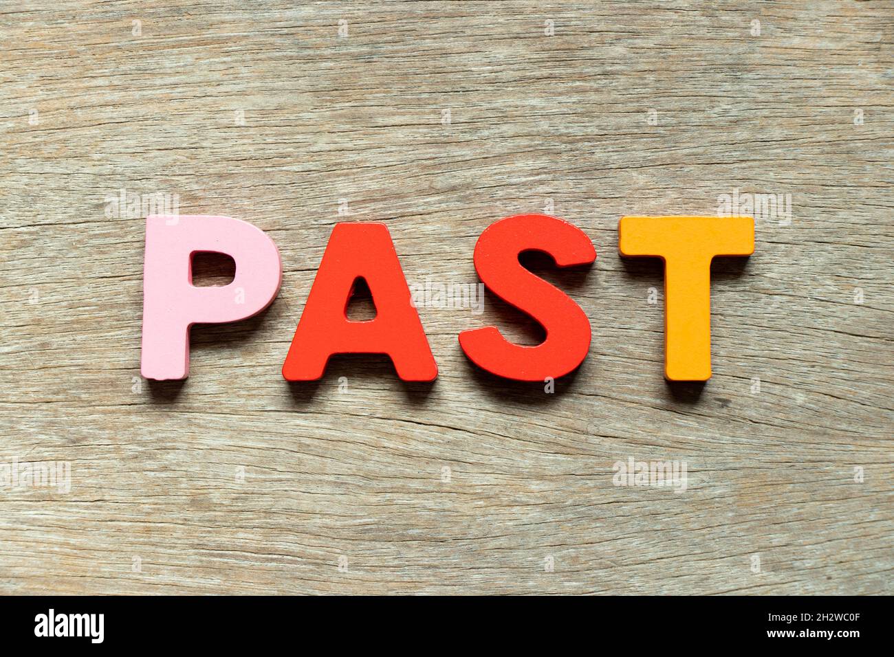 Color alphabet letter in word past on wood background Stock Photo - Alamy