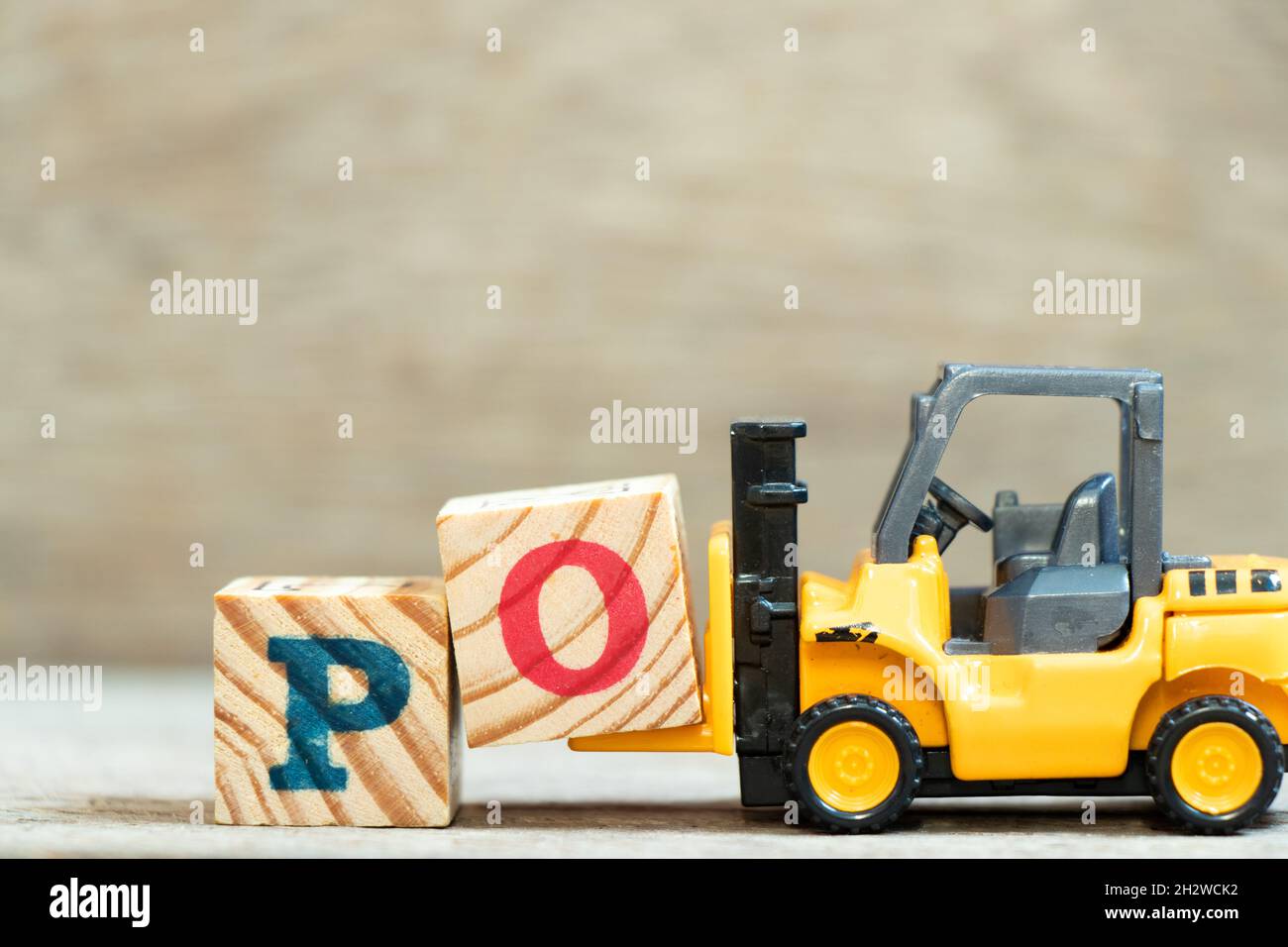 Toy forklift hold letter block o to complete word PO (Abbreviation of ...