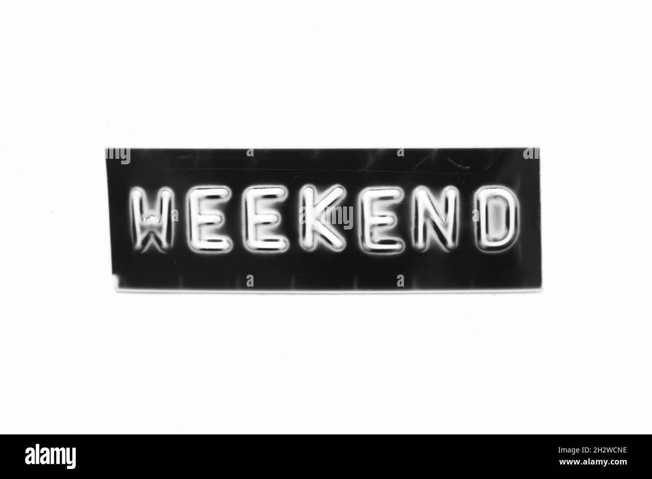 Black color banner that have embossed letter with word weekend on white ...