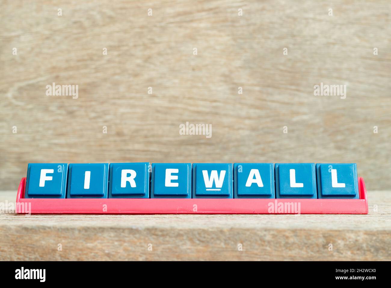 Tile alphabet letter with word firewall in red color rack on wood ...