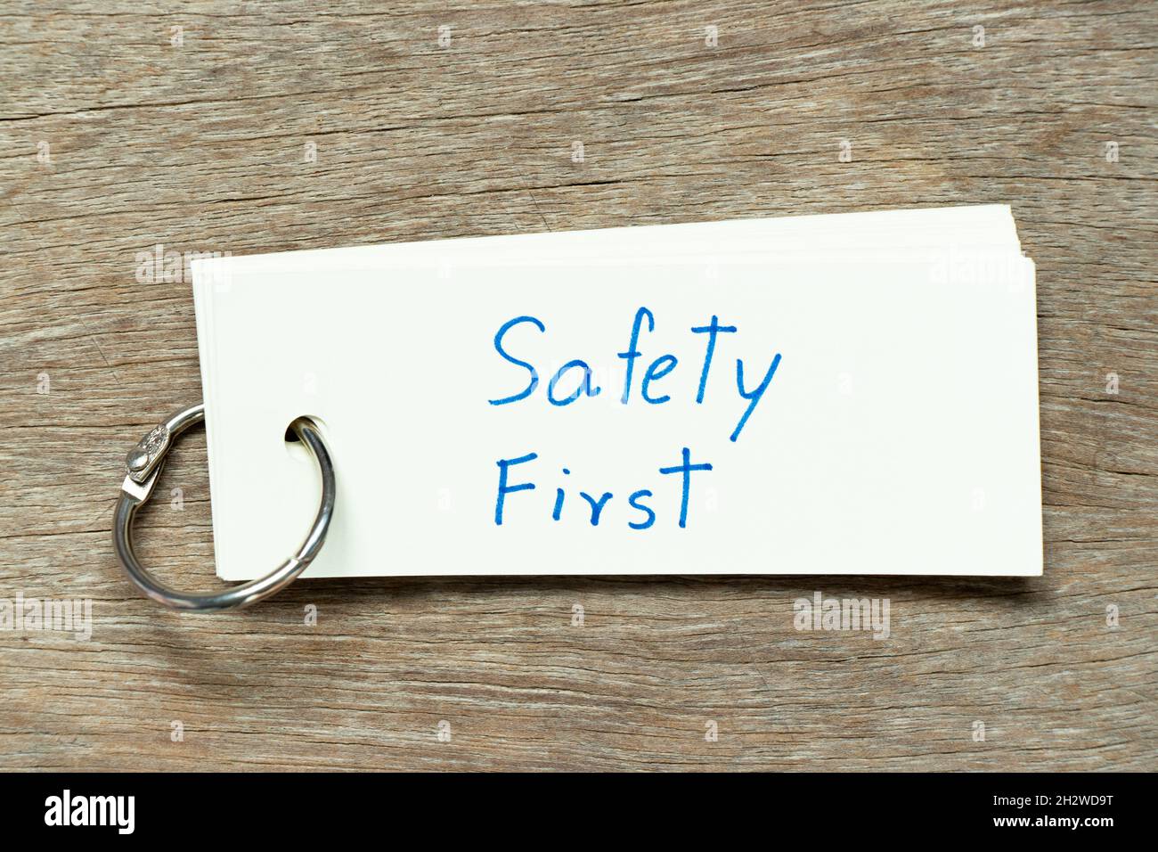 Flash card with handwriting word safety first on wood background Stock ...