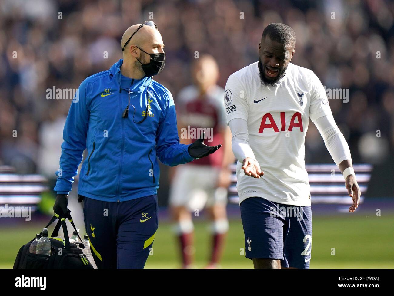 Tottenham Hotspur's Tanguy Ndombele leaves the pitch with a physio ...