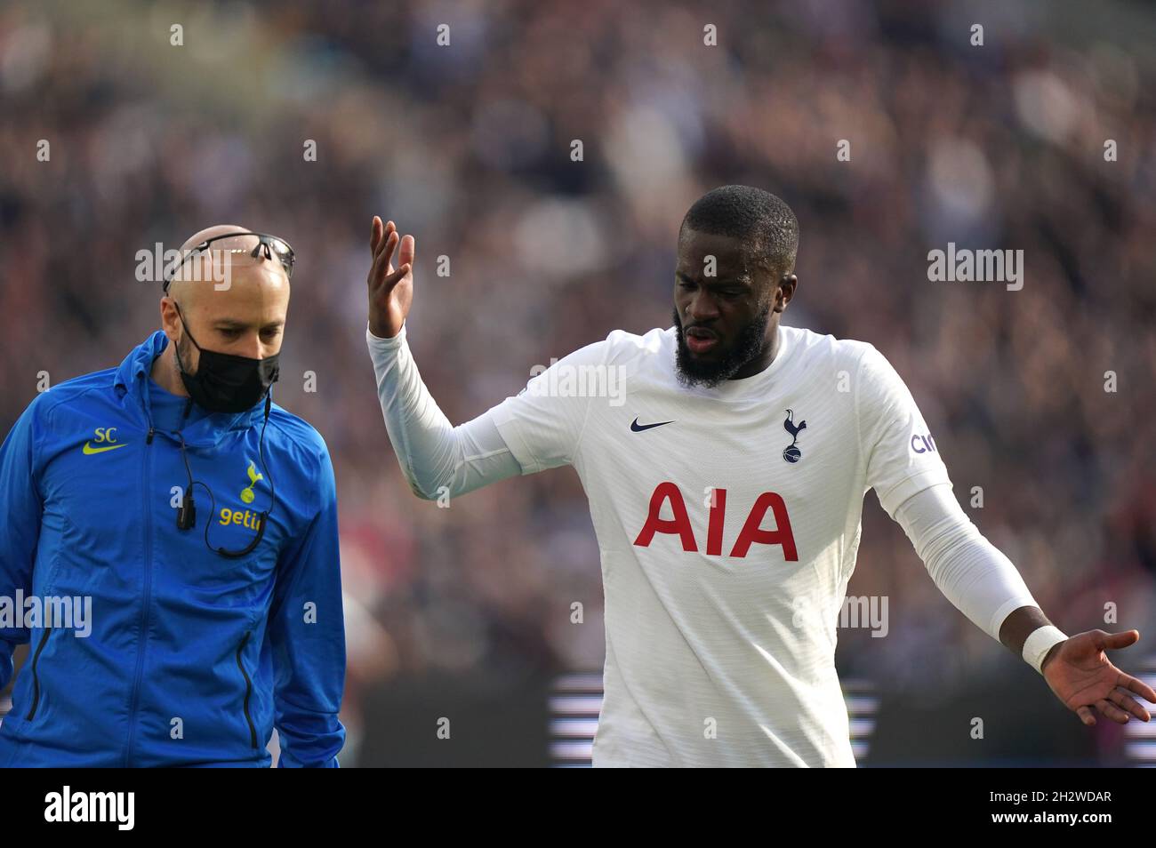 Tottenham Hotspur's Tanguy Ndombele leaves the pitch with a physio ...