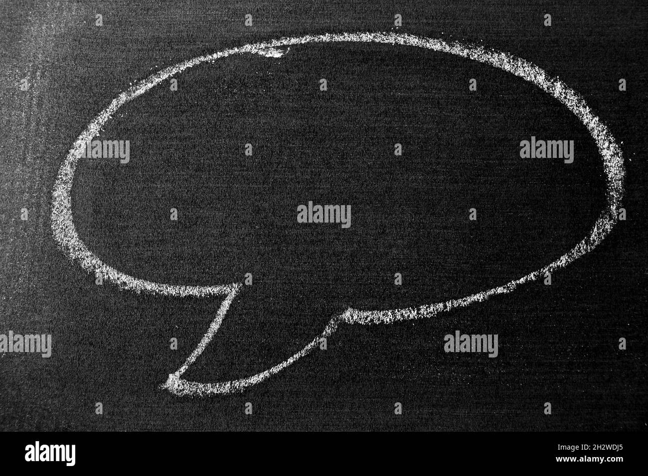 White color chalk hand drawing in round bubble speech shape with blank ...