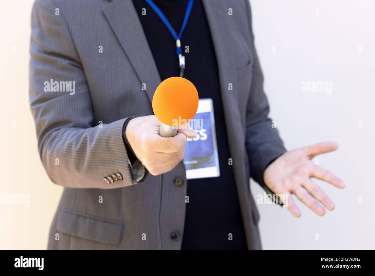 Broadcast journalist gesturing during media interview Stock Photo - Alamy