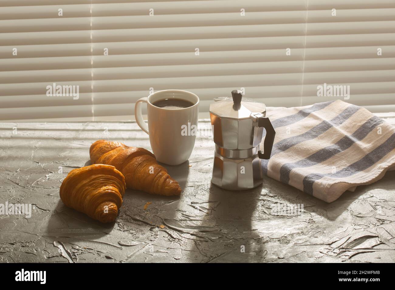 Breakfast with croissant and coffee and moka pot. Morning meal and ...
