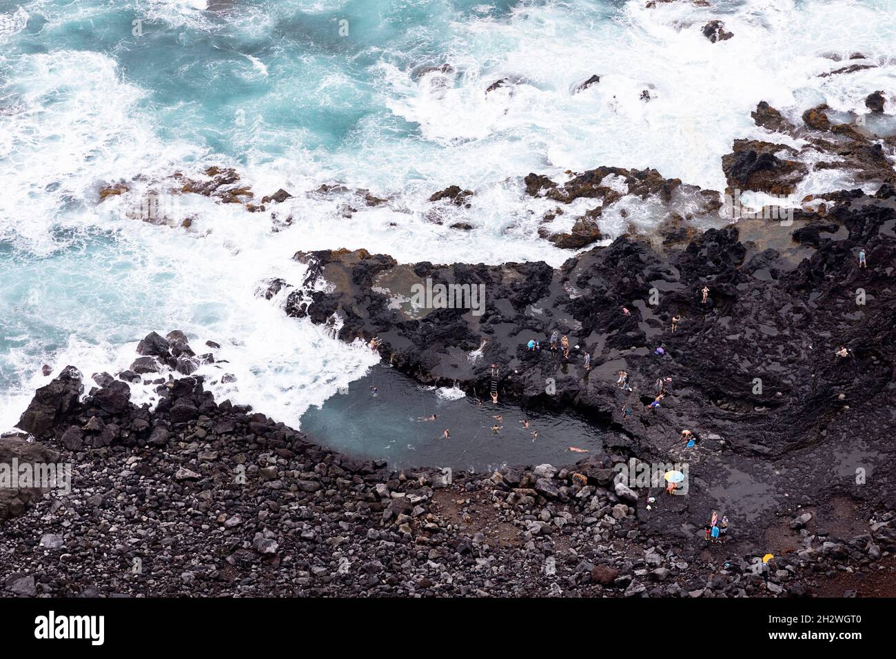 Bathers at natural Pool of Ponta da Ferraria, Sao Miguel, Azores ...