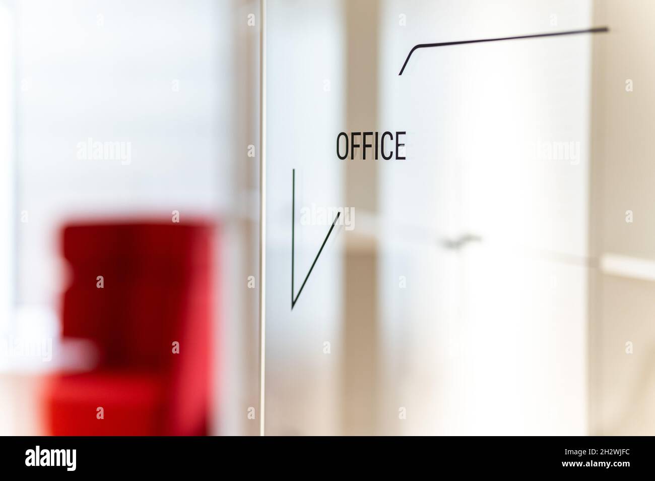 Transparent glass door in the office with the inscription OFFICE. A ...