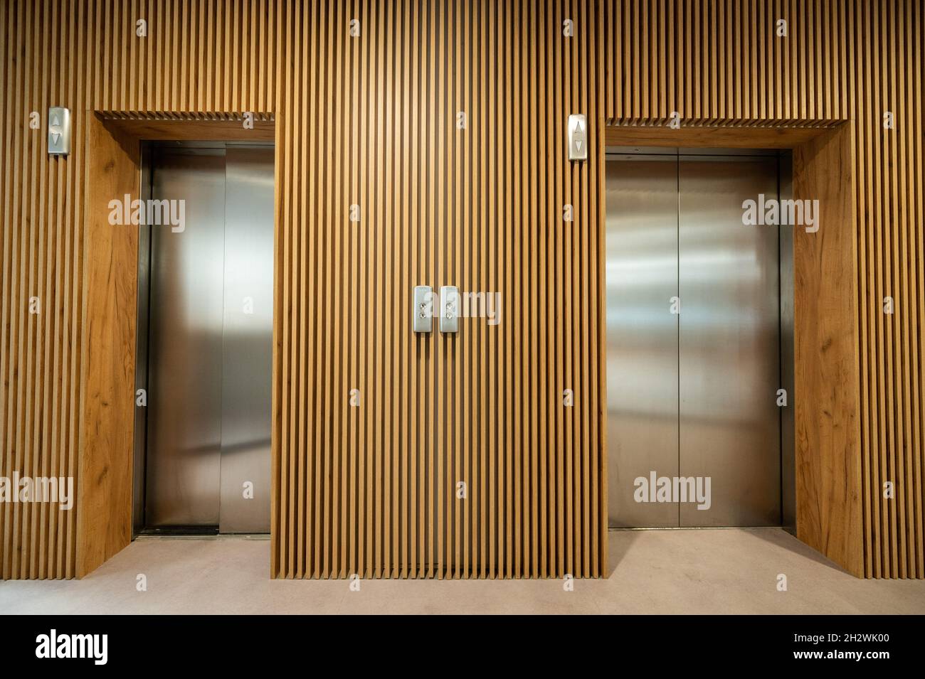 Two modern elevators in a large world corporation Stock Photo - Alamy