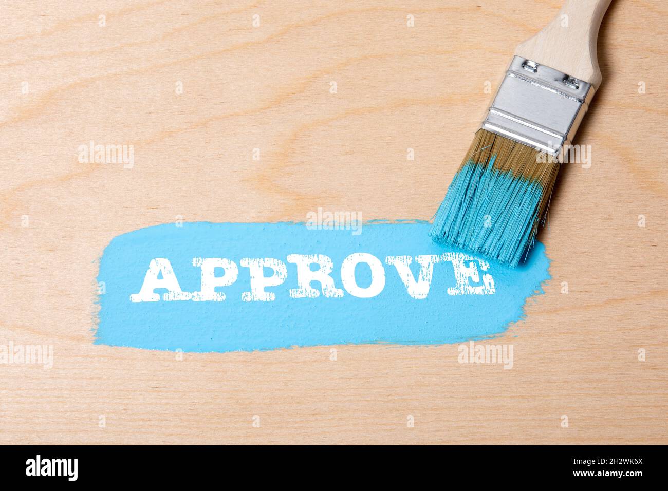 APPROVE. Blue color with a paint brush on a wooden background Stock ...