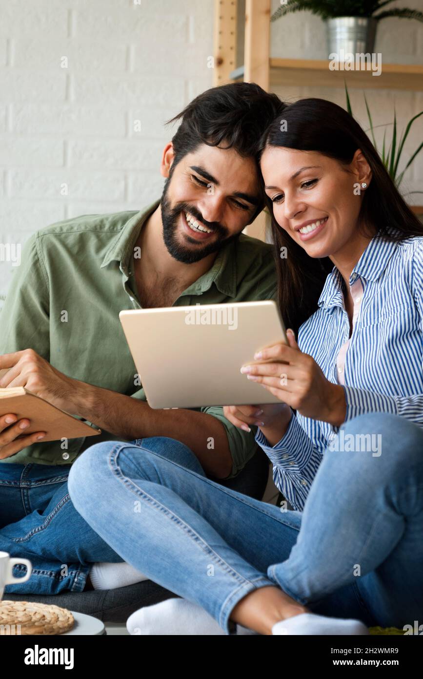 Close up portrait of an attractive married couple using digital tablet ...