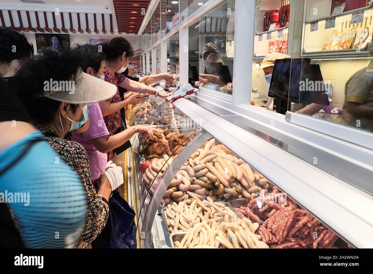 BEIJING, CHINA - Aug 10, 2021: Some people buying varied cooked meat in ...