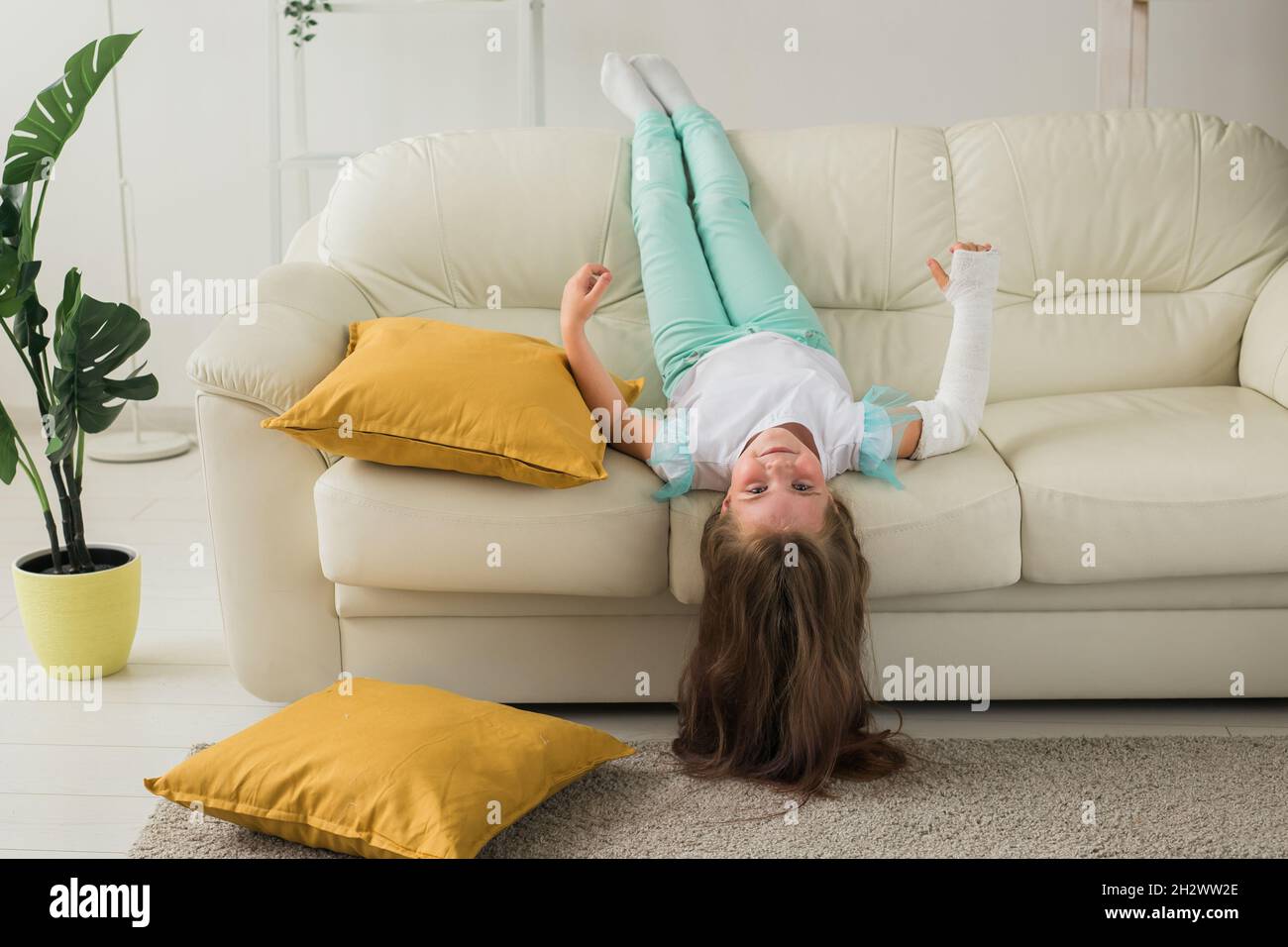 Child with a cast on a broken wrist or arm smiling and having fun on a ...