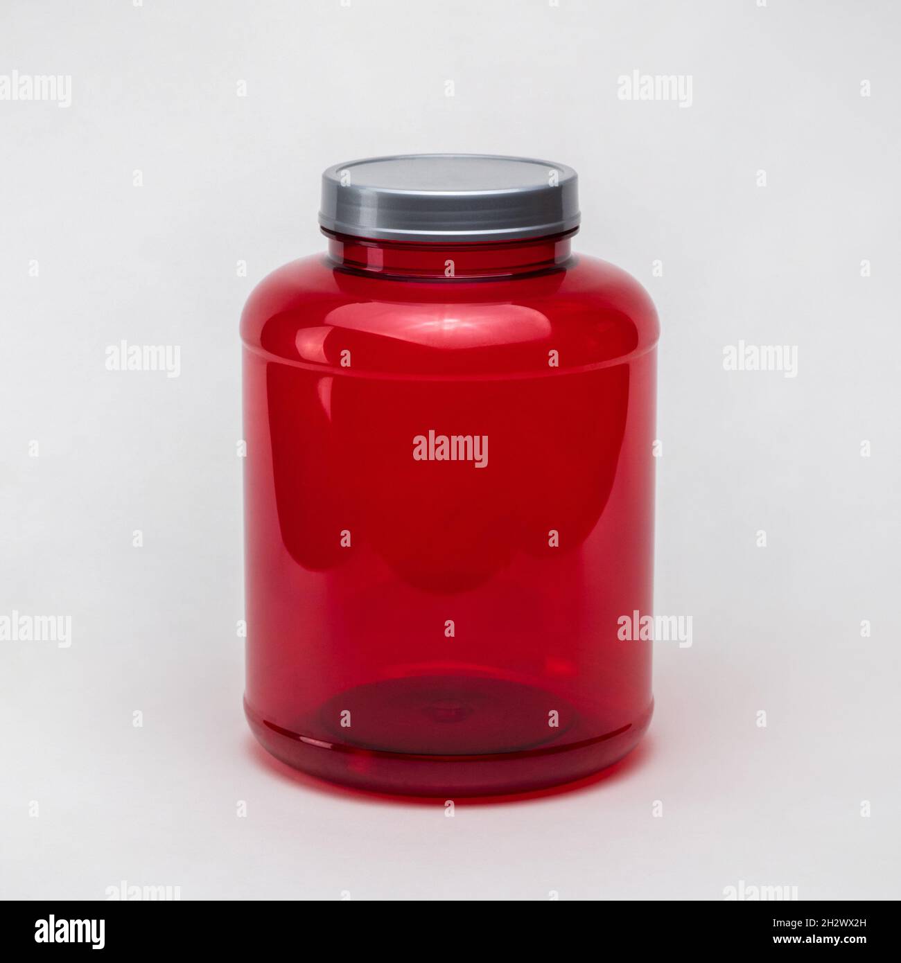 Large red transparent plastic pill jar on white background. Isolated ...