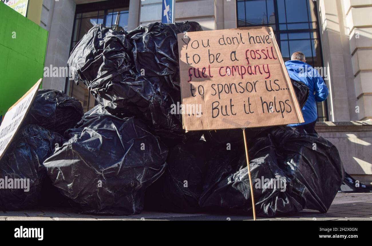 Fake coal and a placard critical of fossil fuel company sponsorship are ...