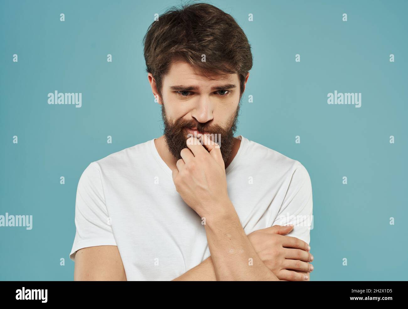 emotional man in a white t-shirt hand gestures anger Studio Stock Photo ...