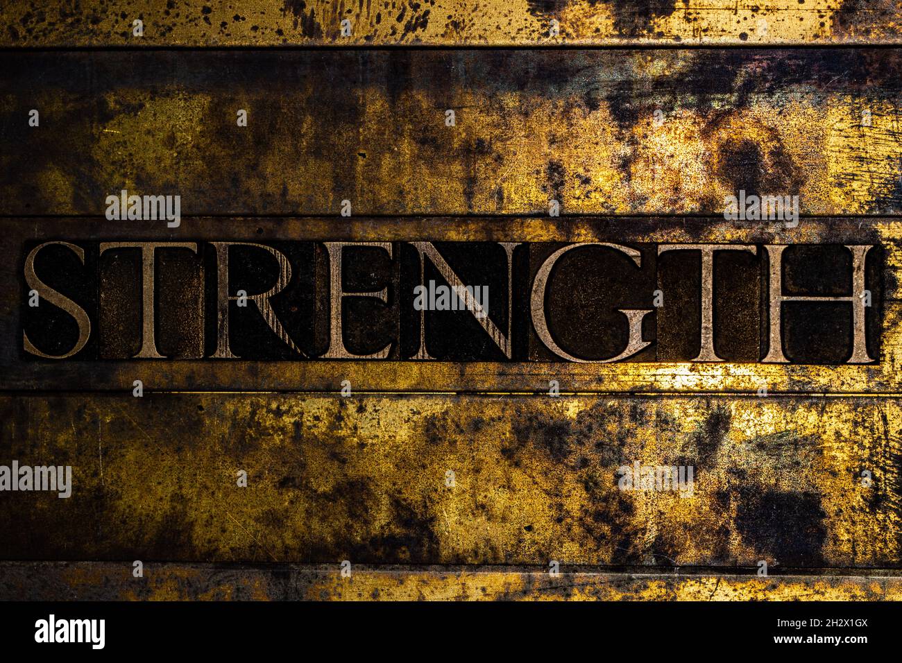 Strength text on textured grunge copper and vintage gold background ...