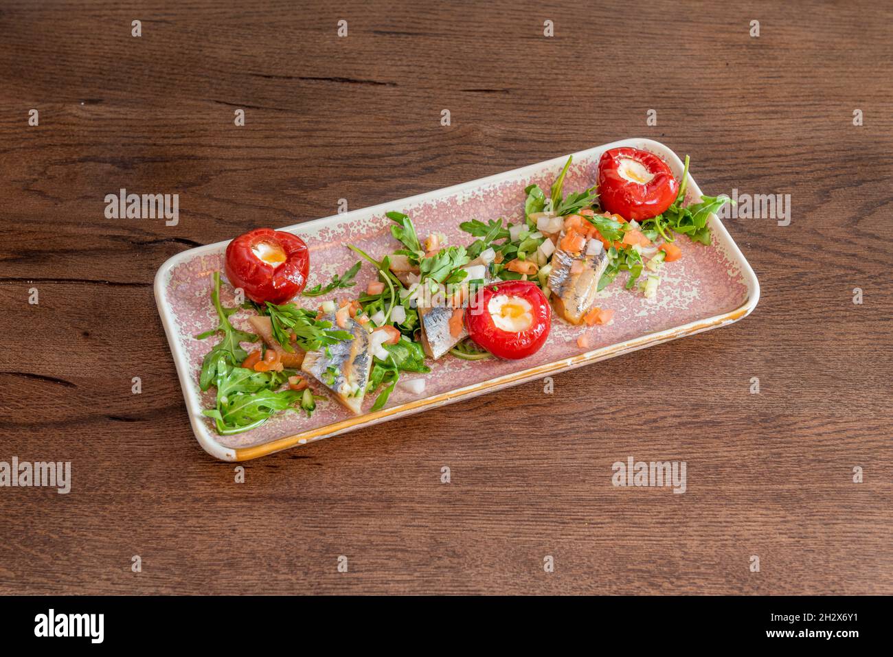 Chopped sardine tapa with cherry peppers stuffed with fresh cheese ...