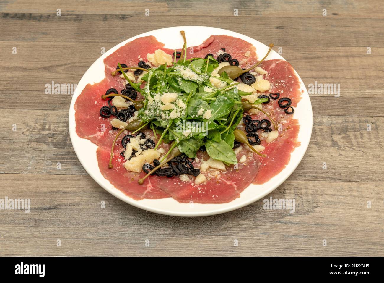 Delicious Italian recipe for carpaccio with parmesan cheese, slices of ...
