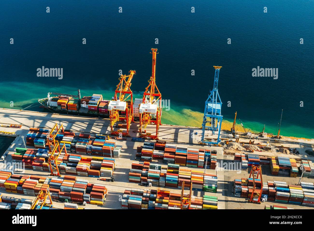 Aerial view of containers loading and unloading to the ship in the sea ...