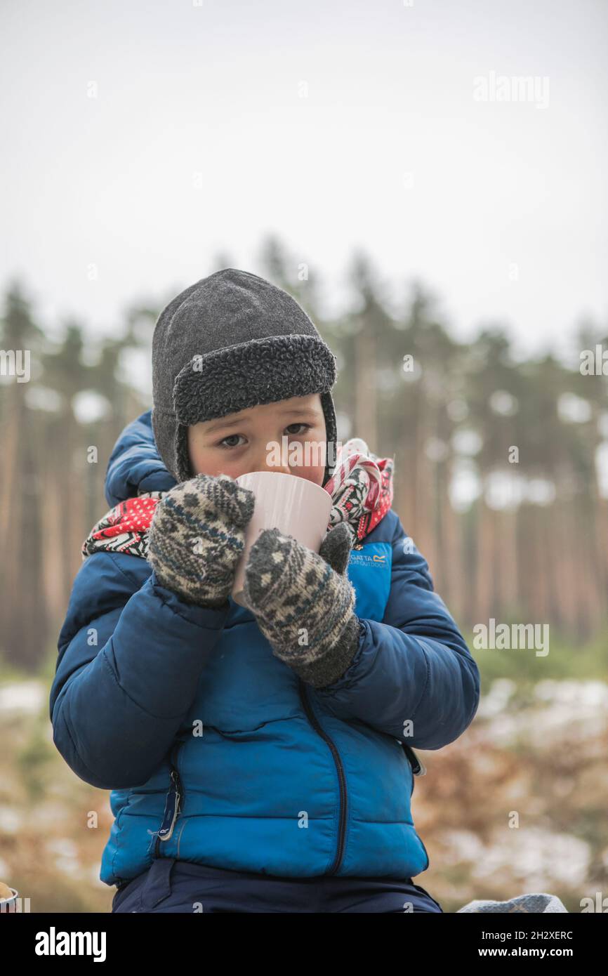Christmas holidays, boy drinking hot New Year beverage. Happy family on ...