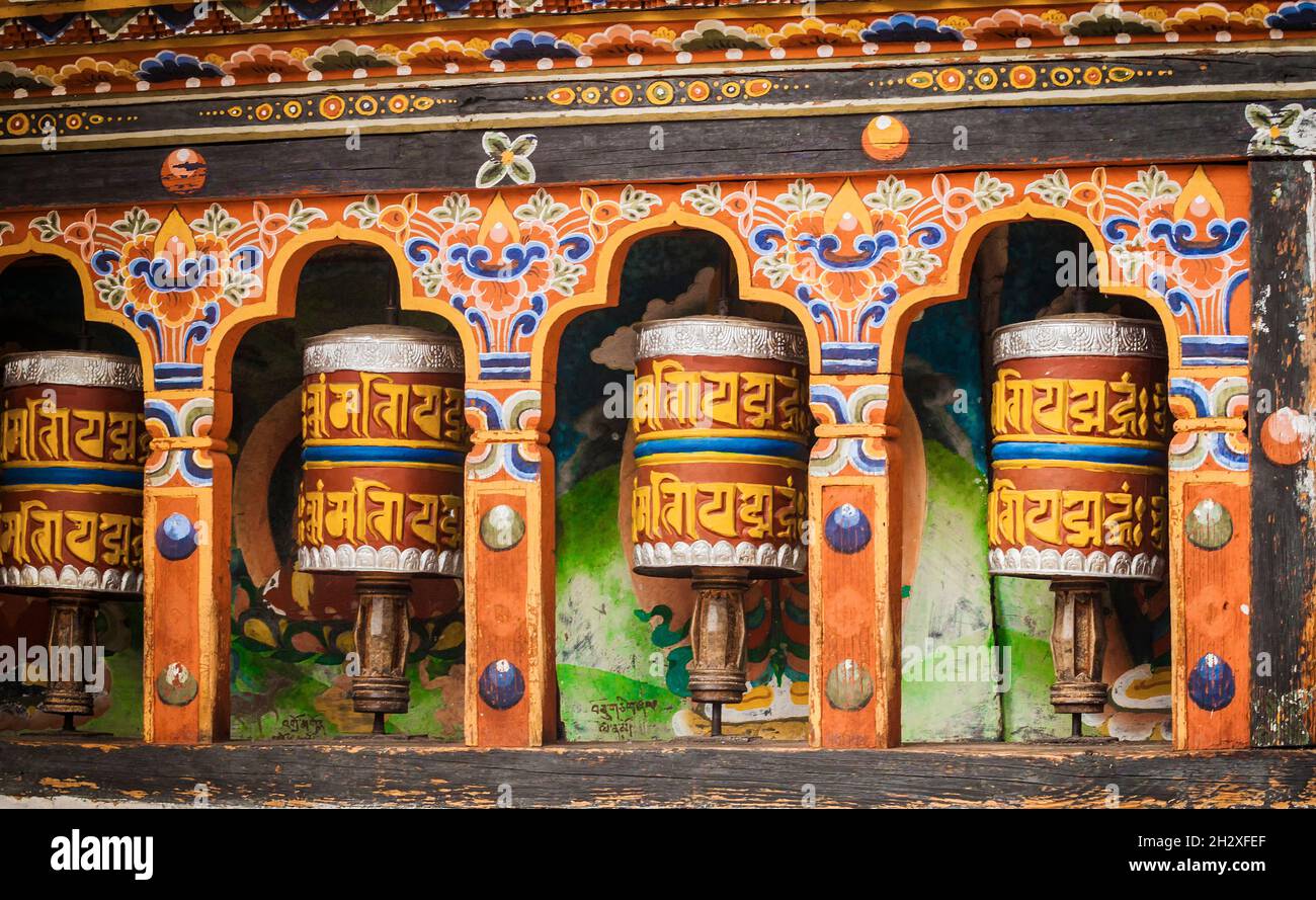 Turning prayer wheels mantra in Bhutan with traditional writing mantra ...