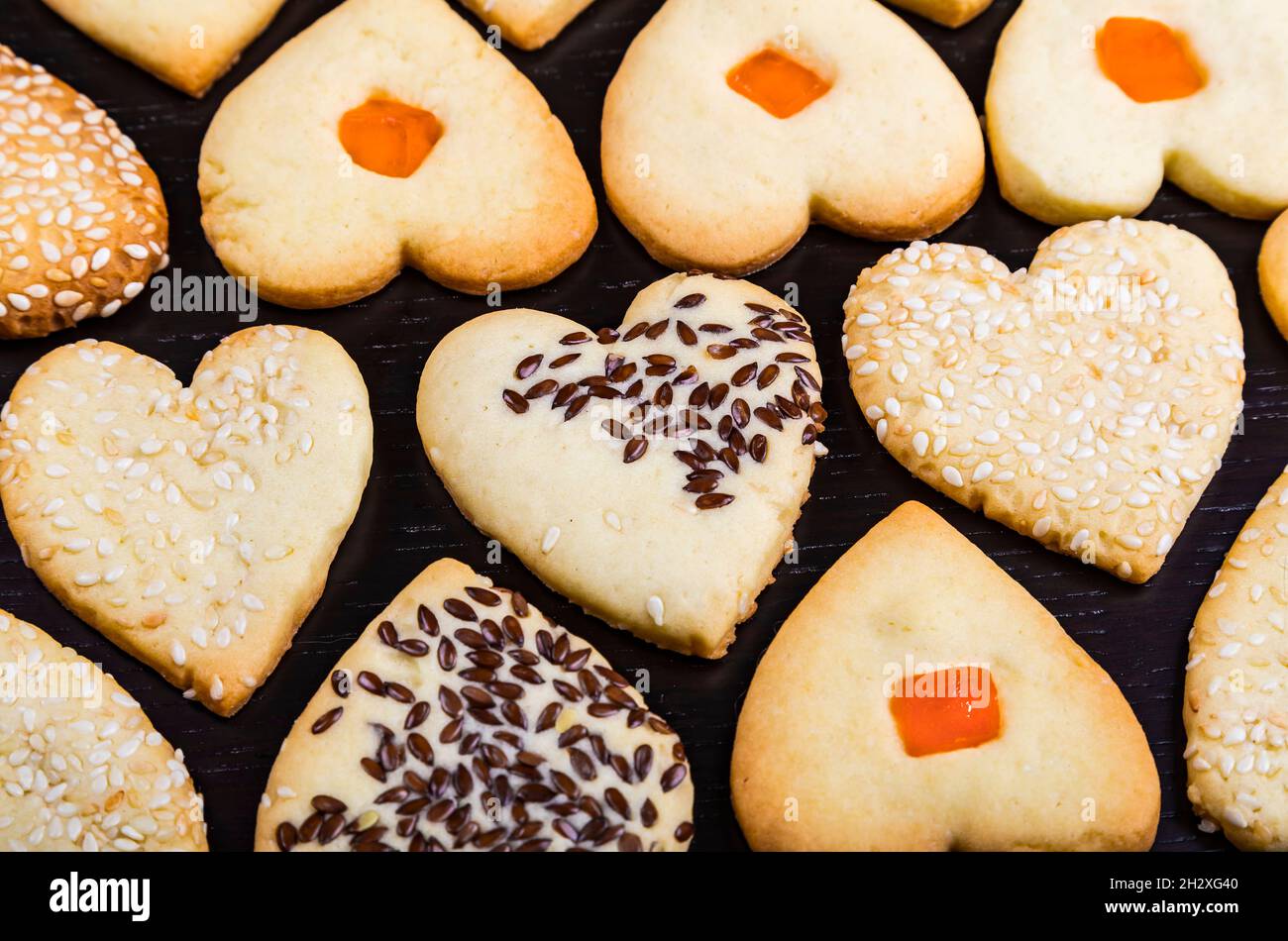 Background of homemade heart shaped cookies with sesame seeds, flax ...