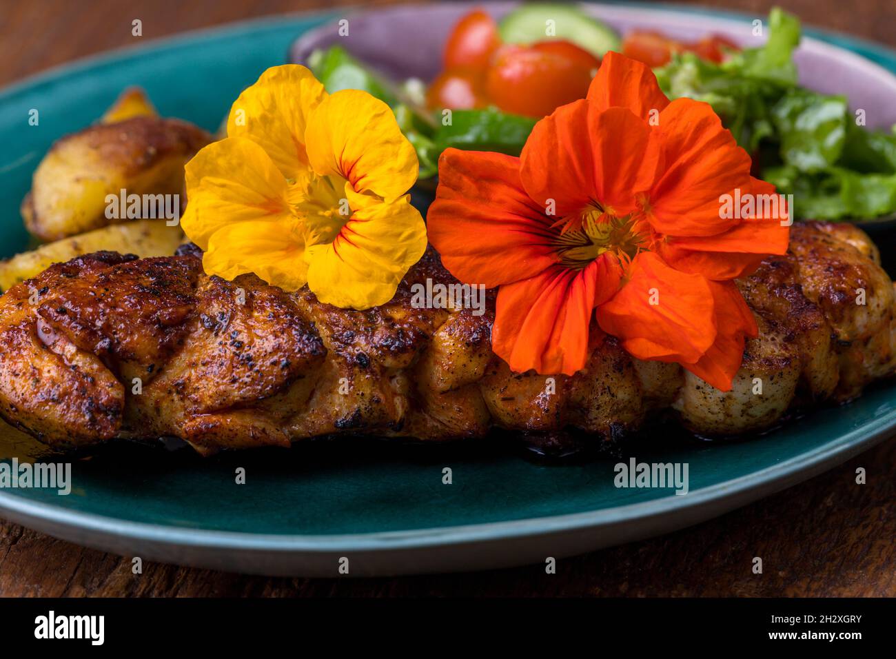 nasturtium flowers on a grilled steak Stock Photo - Alamy